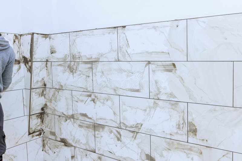 Ceramic Tiles are Grouted with a Rubber Trowel by Tilers Filling Gap ...