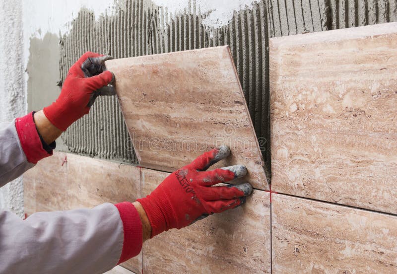 Ceramic Tiles. Tiler Placing Ceramic Wall Tile in Position Over Stock ...