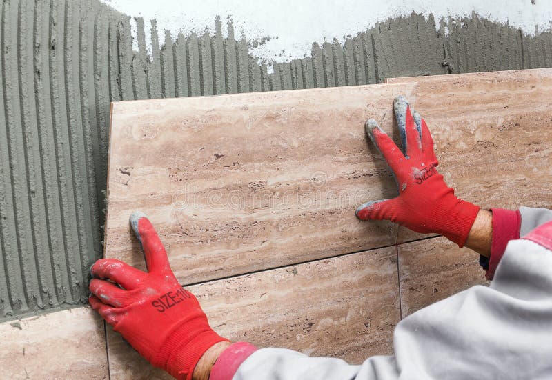 Ceramic Tiles. Tiler Placing Ceramic Wall Tile in Position Over Stock ...