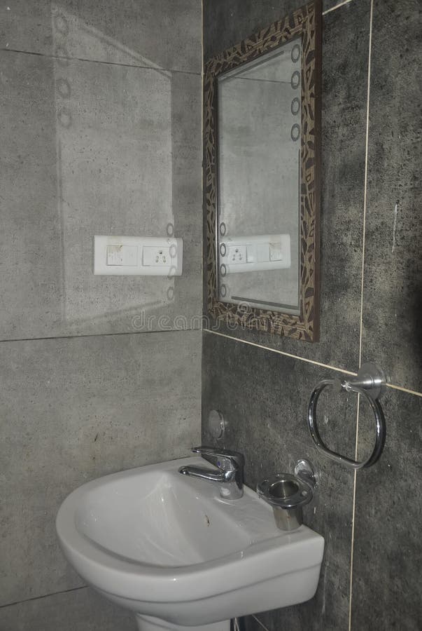 Ceramic Wash Basin and Mirror on the Tiled Wall Inside Modern Bathroom ...