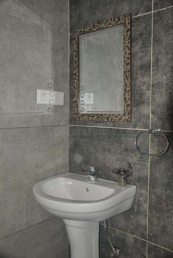Ceramic Wash Basin and Mirror on the Tiled Wall Inside Modern Bathroom ...