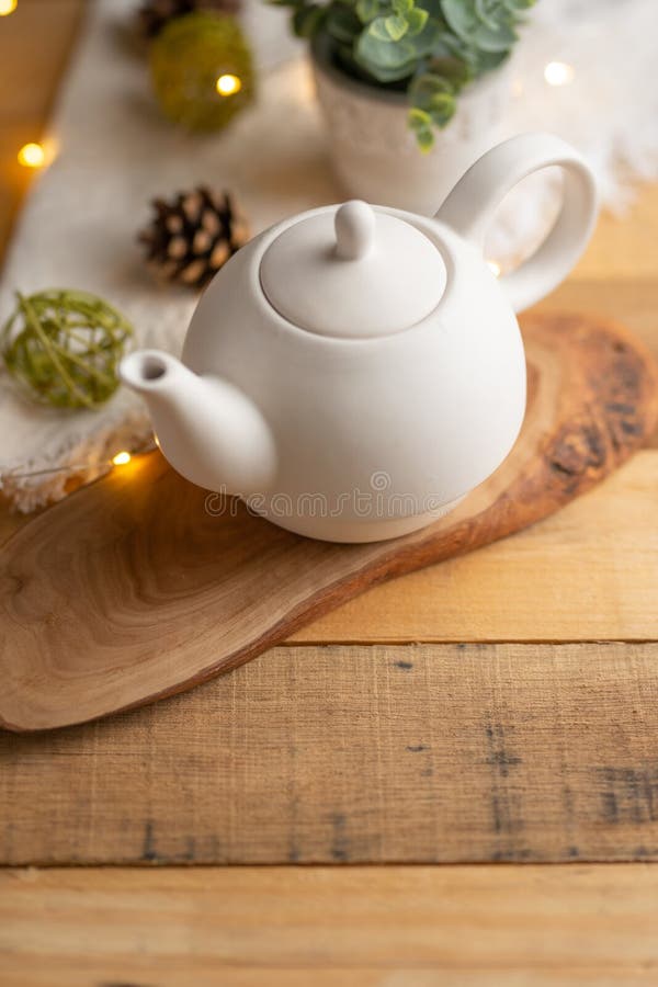 Ceramic White Teapot with Accessories on a Wooden Table, Vertical Frame ...