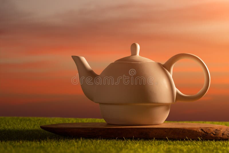 Ceramic White Teapot on Green Grass at Sunset Background Stock Photo ...