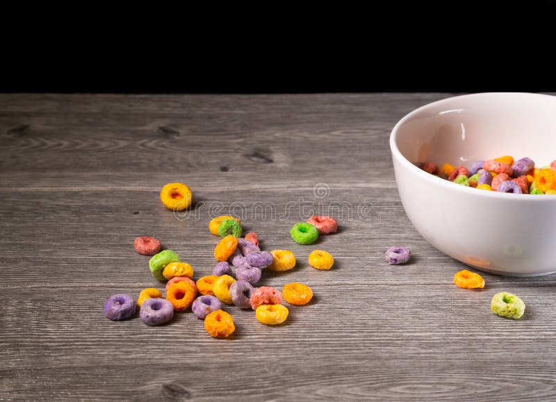 Cereal on a Gray Table with a Bowl on One Side with Colorful Cereal ...