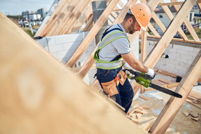 Certified Builder Using a Chainsaw at a Constraction Site Stock Image ...