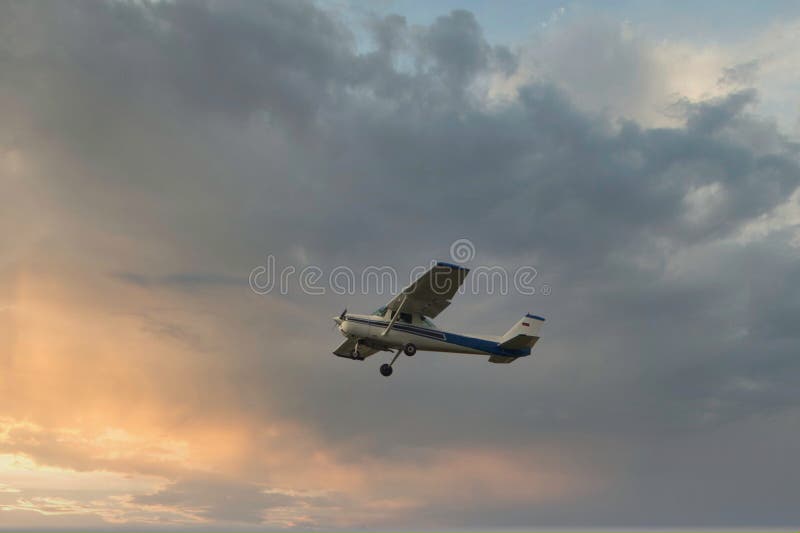 Cessna Plane Flying at Sunset in the Clouds Stock Photo - Image of ...
