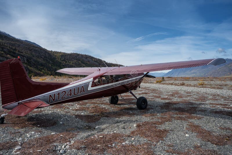 Cessna Skywagon Parked on the Field with Mountains and the Blue Sky in ...