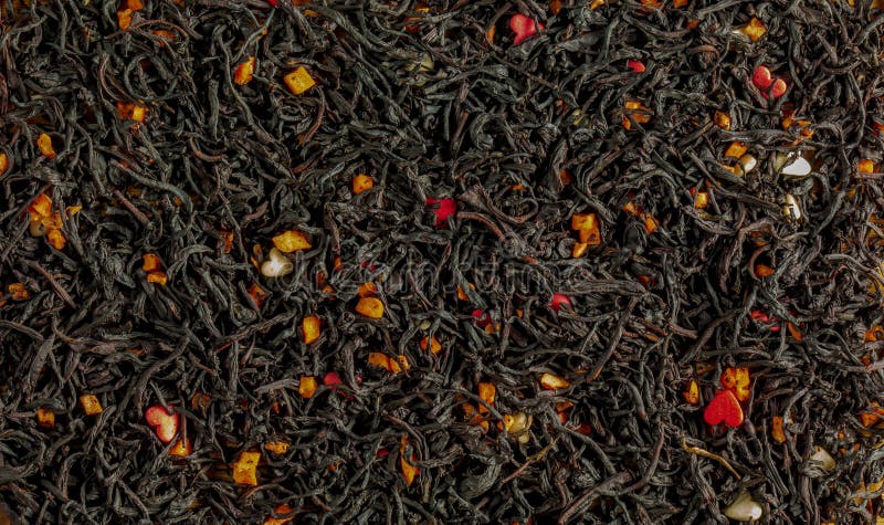 A Ceylon Black Tea. Background of Leaf Tea with Pieces of Passion Fruit ...