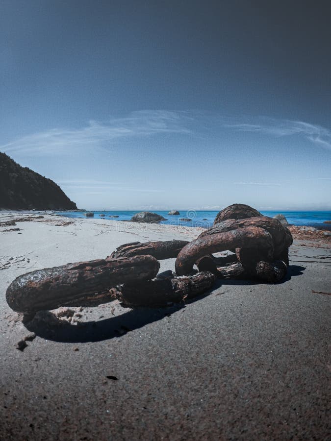 Chain on the beach stock photo. Image of wave, rock - 185862228