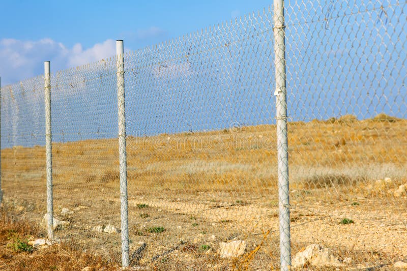 Chain Link Fence with a Field Behind it Stock Image - Image of steel ...