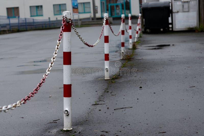 Chain-linked Posts Line a Wet Surface in an Empty Parking Area Stock ...