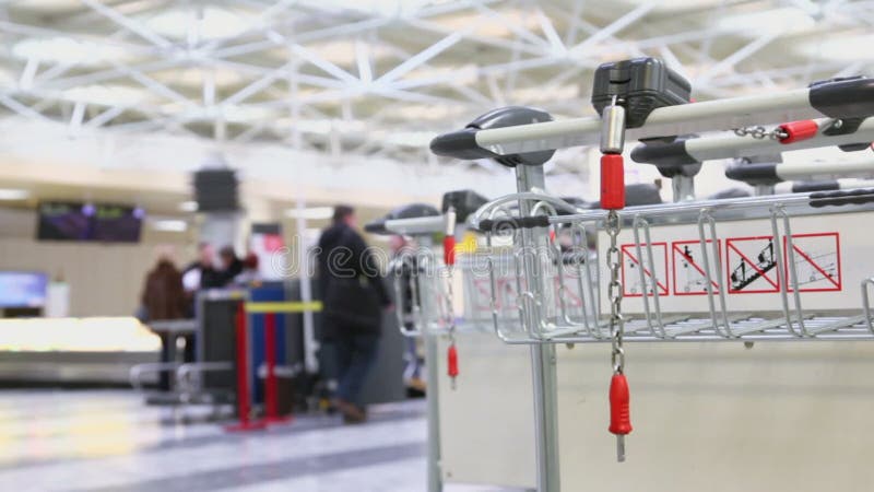Chain on Luggage Cart in Airport with Passengers Stock Video - Video of ...