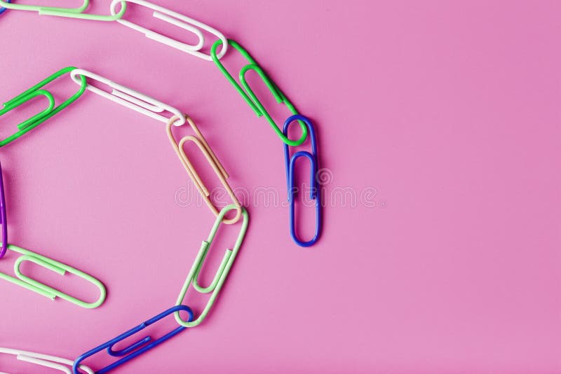 A Chain of Multi-colored Paper Clips on a Pink Background Stock Photo ...