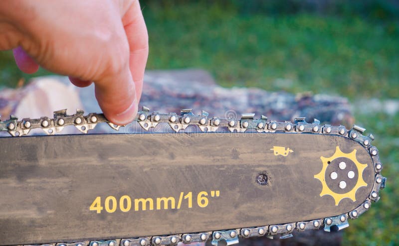 Chain Saw. Saw Bar and Chain Saw Chain Close Up. Checking the Chain ...