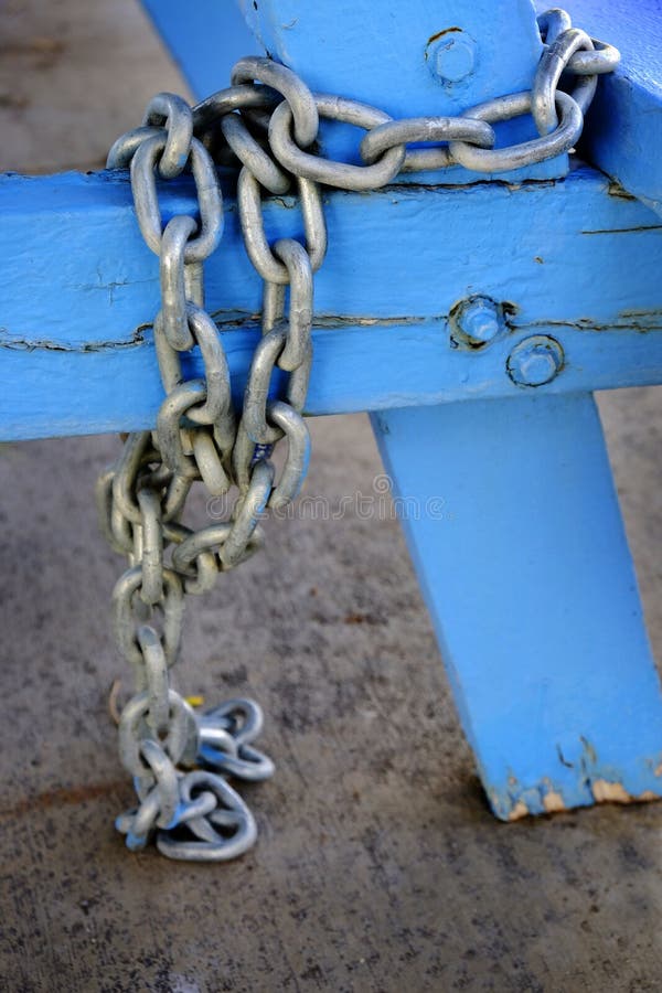 Chain Wrapped Around Blue Wood for Security Stock Photo - Image of ...
