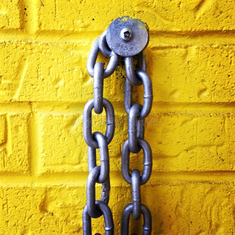 Chain on a Yellow Brick Wall Stock Photo - Image of square, composition ...