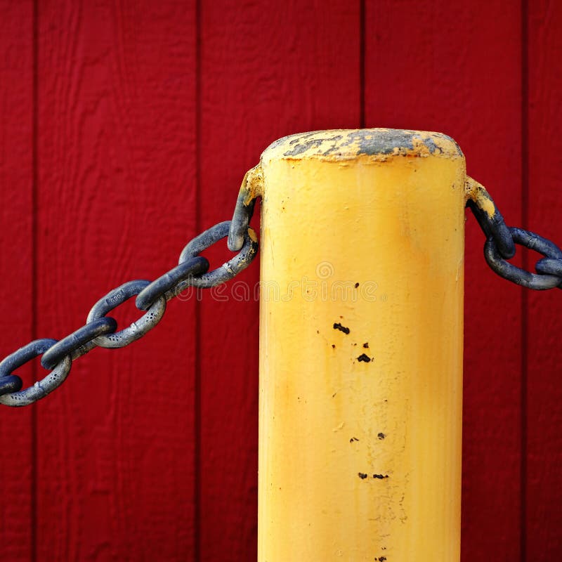 Chain and Yellow Pole for Security with Red Wall Background Safety ...