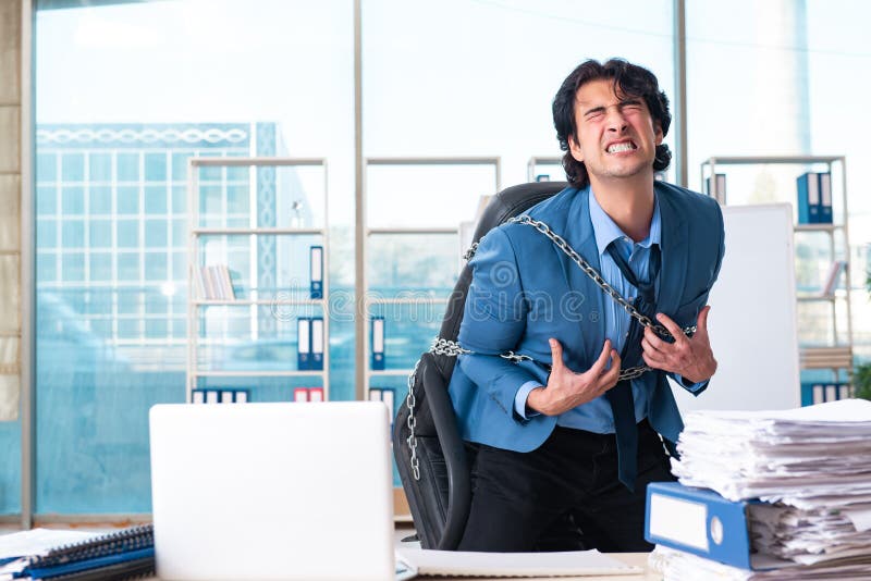 The Chained Male Employee Unhappy with Excessive Work Stock Photo ...