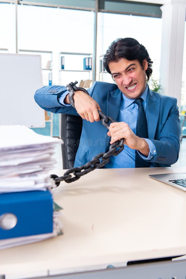 The Chained Male Employee Unhappy with Excessive Work Stock Image ...