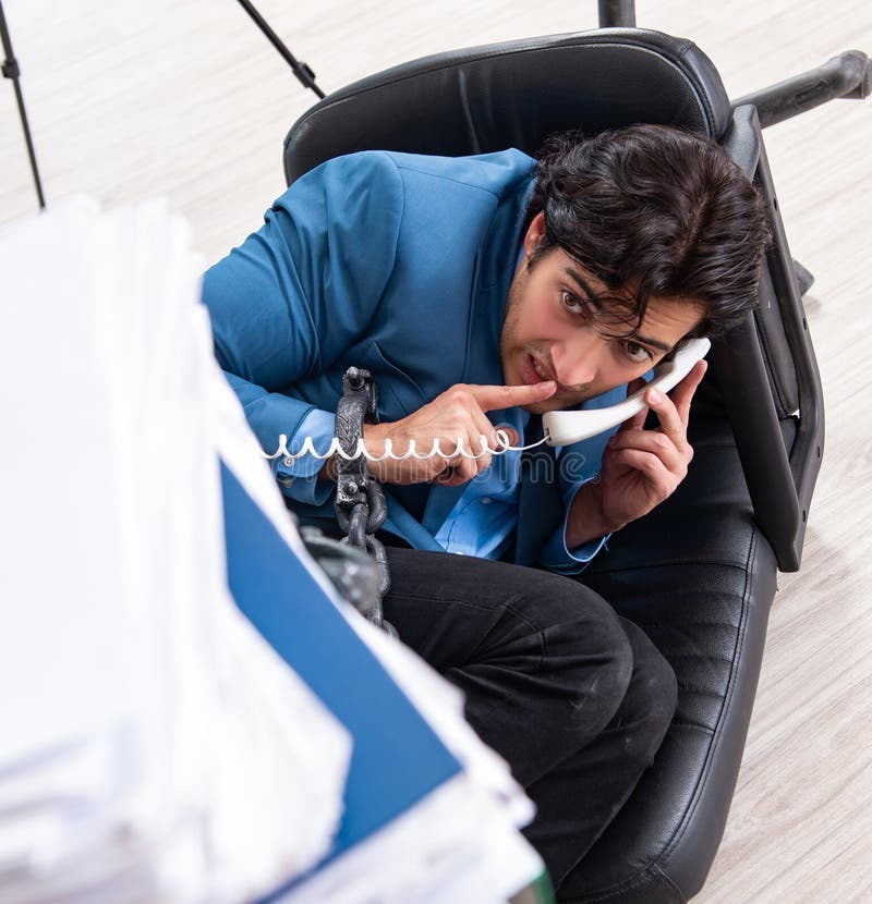 Chained Male Employee Unhappy with Excessive Work Stock Photo - Image ...
