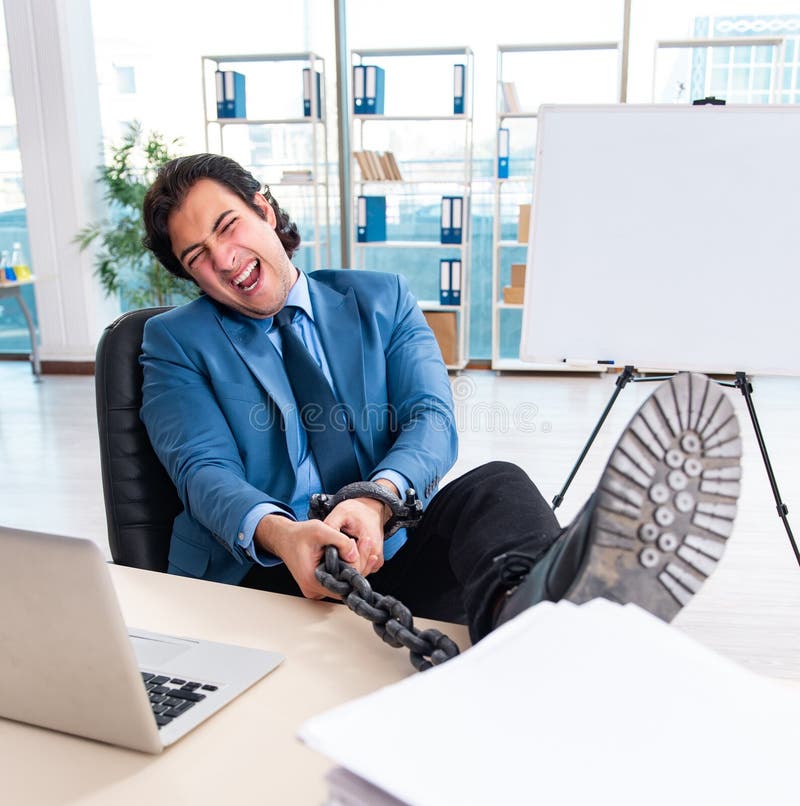 Chained Male Employee Unhappy with Excessive Work in the Office Stock ...