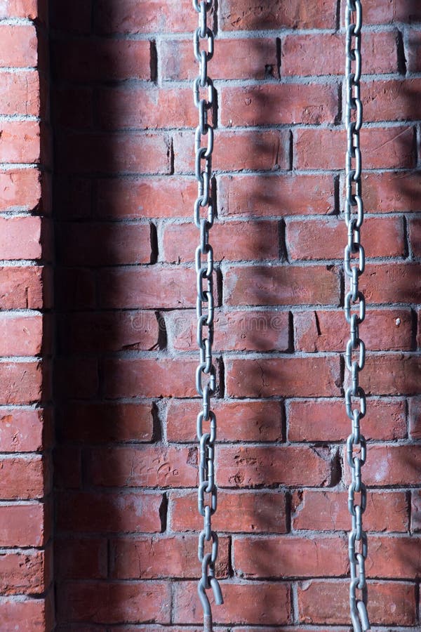 Chains on a brick wall stock photo. Image of chain, chandelier - 194694688