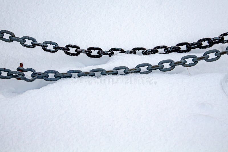 Black and Grey Steel Chains Suspended Across Snow Stock Photo - Image ...