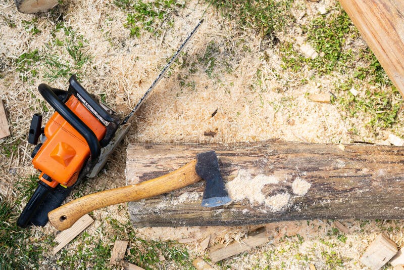 Chainsaw and Ax on a Freshly Cut Log. Work Process. Stock Photo - Image ...