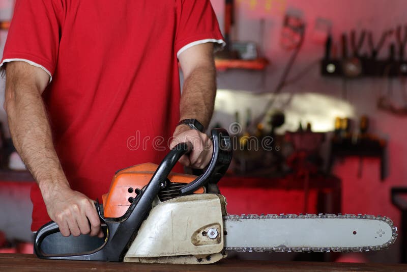 Chainsaw with a Person in the Garage Stock Photo - Image of orange ...