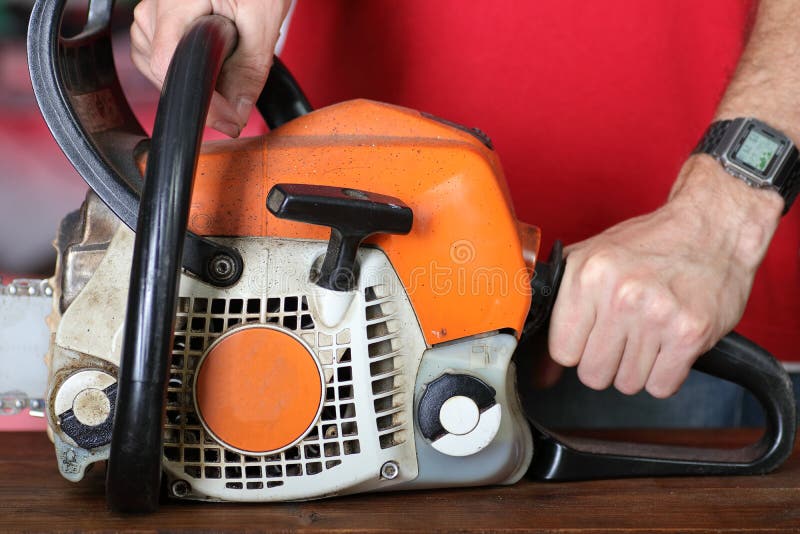 Chainsaw with a Person in the Garage Stock Photo - Image of headless ...