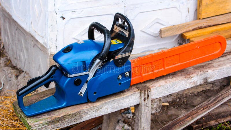 A Chainsaw is Standing on a Bench a Chainsaw with a Tire and a Casing ...
