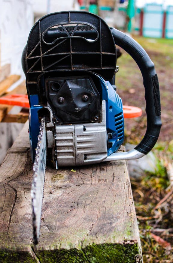 A Chainsaw is Standing on a Bench a Chainsaw with a Tire and a Casing ...