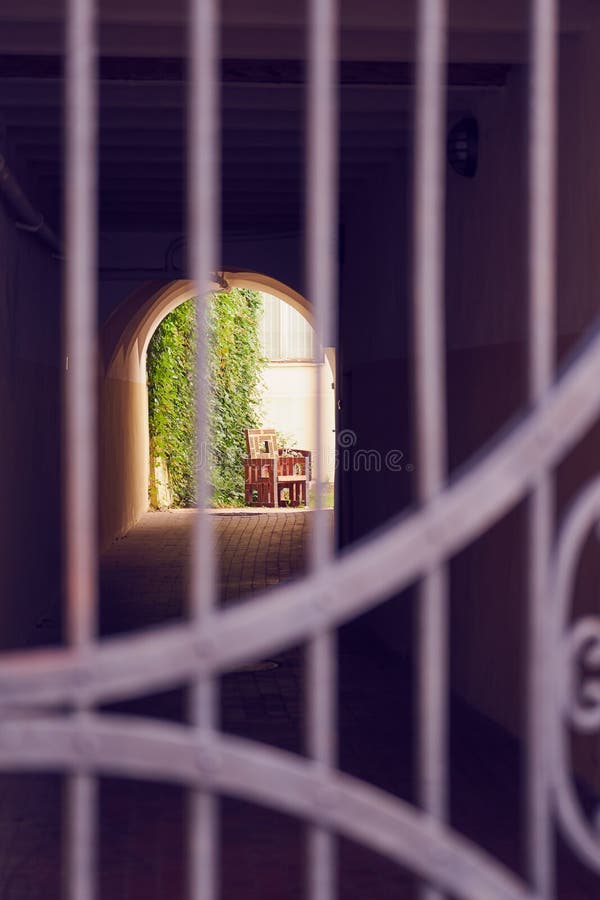 A Chair Made of Bricks in the Courtyard Behind an Iron Fence. Stock ...