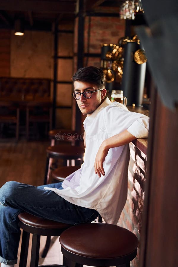On the Chair. Man in Casual Clothes Sitting in the Pub Stock Image ...