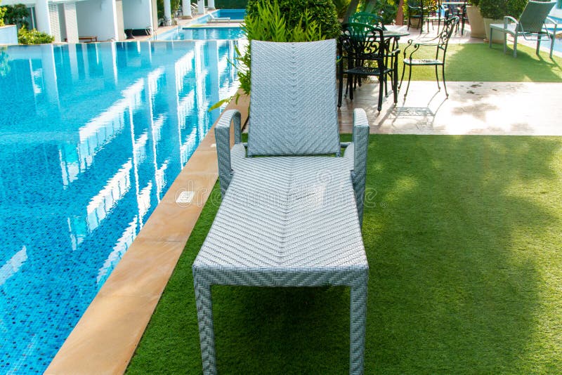Chair near swimming pool stock photo. Image of lounger - 92669704