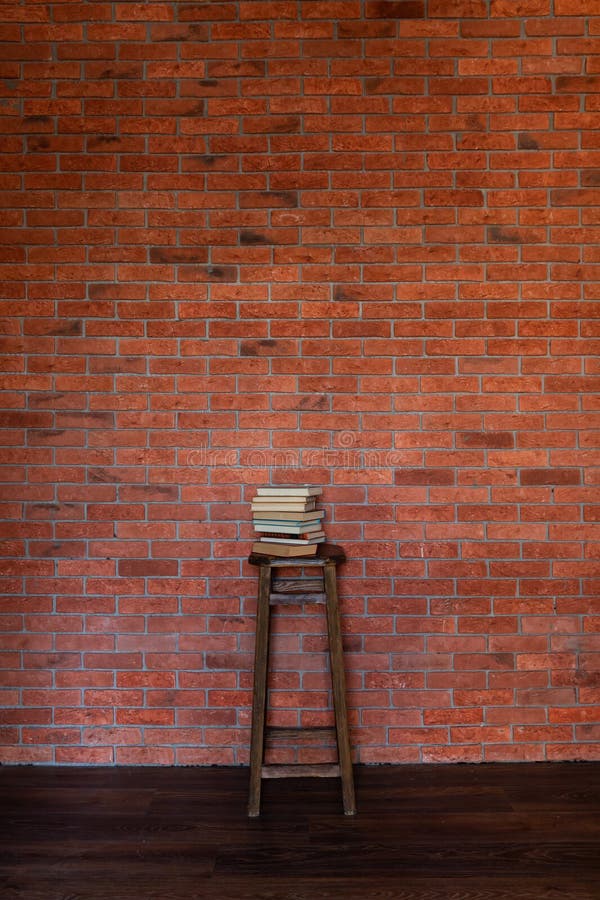 Chair and Stack of Books by Brick Wall Stock Image - Image of brick ...