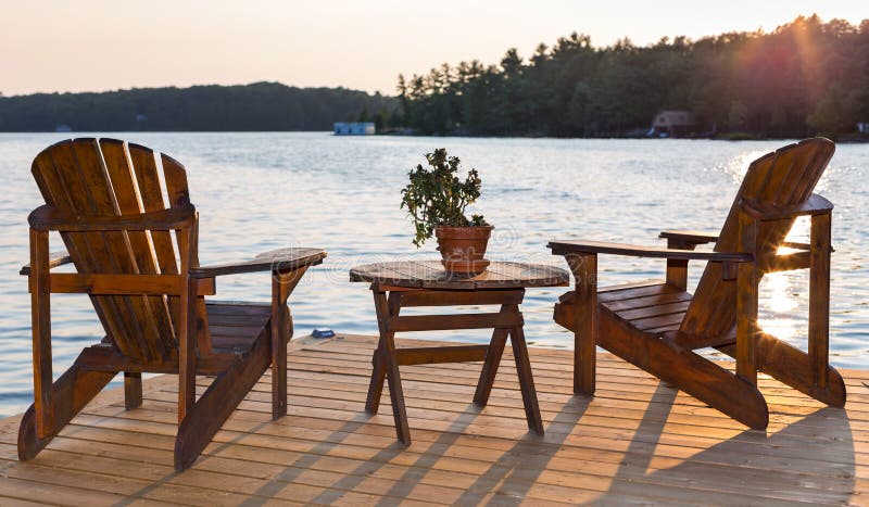 Chairs on a Deck Overlooking a Lake at Sunset. Stock Photo - Image of ...