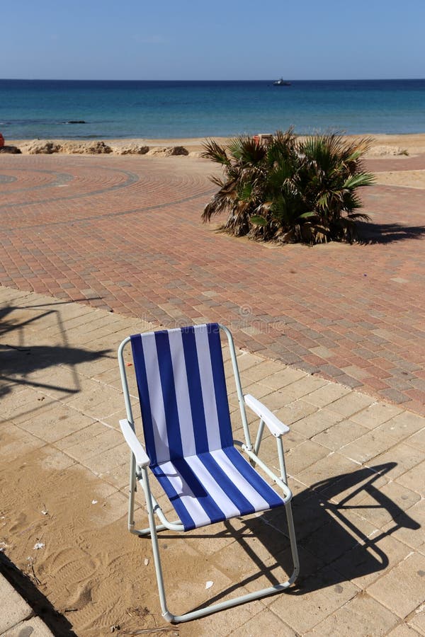 Chairs by the sea stock image. Image of city, legs, seat - 131555387