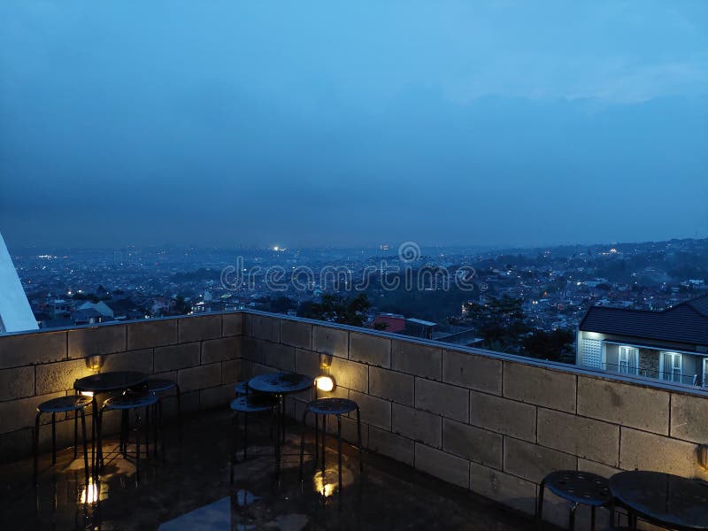 Chairs and Tables in a Cafe. with Small Town View at Night with Rain ...
