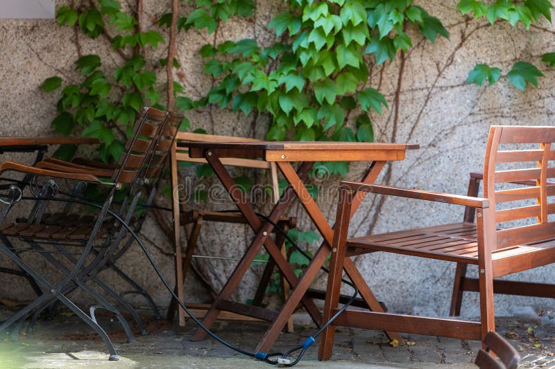 Chairs and Tables in Front of a House Wall Stock Photo - Image of table ...