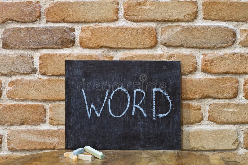 Chalk Board with the Word WORD Drown by Hand and Chalks on Wooden Table ...