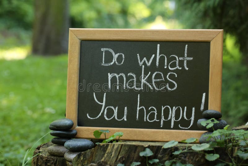 Chalkboard with Phrase Do What Makes You Happy on Stump Outdoors Stock ...