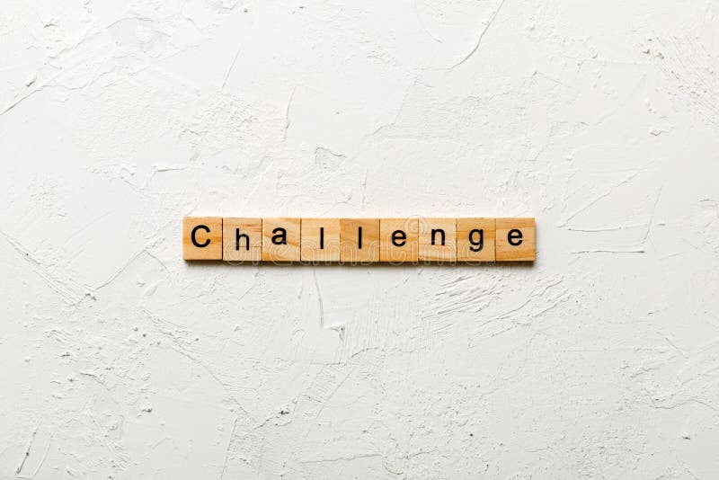 CHALLENGE Word Written on Wood Block. CHALLENGE Text on Cement Table ...