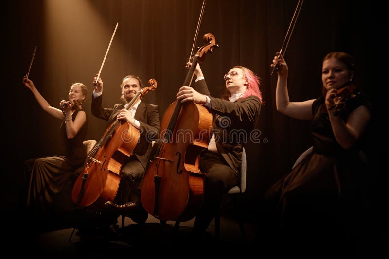 Four Professional String Players Giving Concert on Stage Stock Image ...