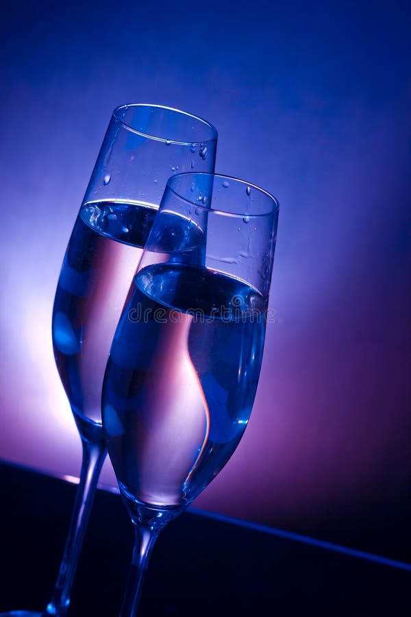 Champagne Flutes on Bar Table on Dark Blue and Violet Light Background ...