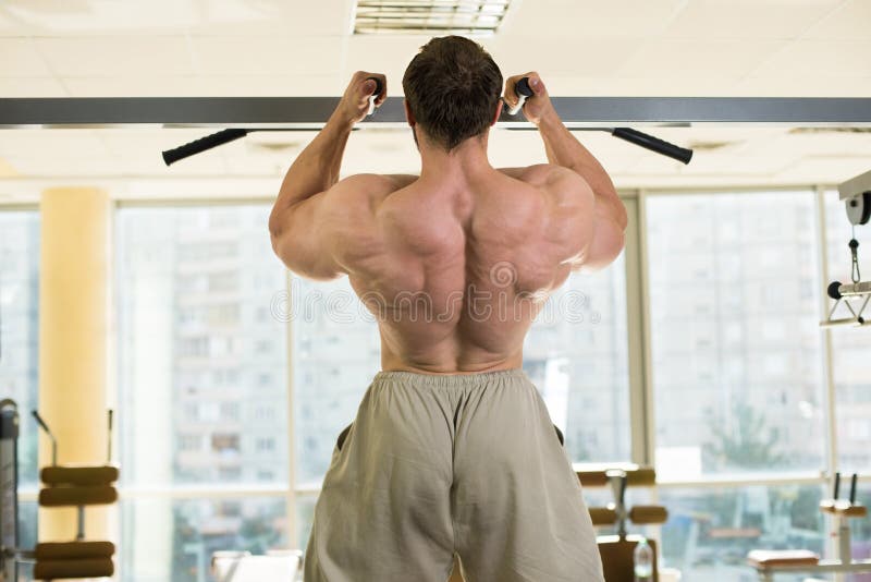 Champion doing pull-ups. stock photo. Image of biceps - 64830962