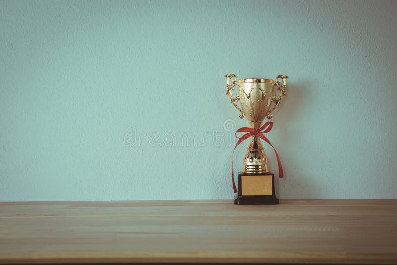 Champion Golden Trophy on Wood Table with Spot Lights on Background ...