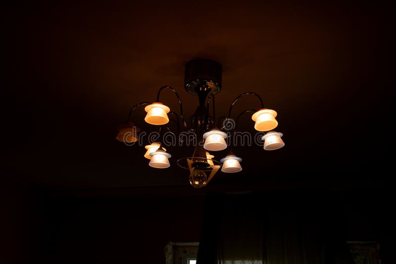 Chandelier on the Ceiling in the Apartment at Night Glows and ...