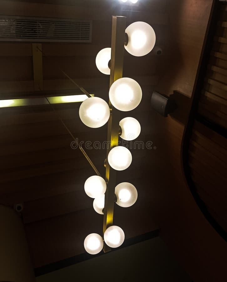 A Chandelier Designed with a Light Bulb Attached To an Iron Rod Stock ...