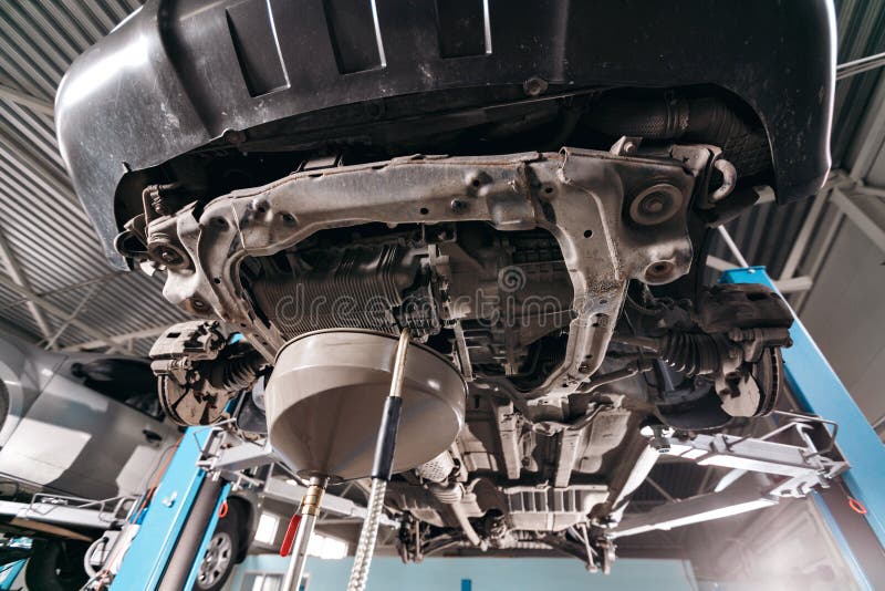 Change Engine Oil. Working Underneath a Lifted Car Stock Image - Image ...